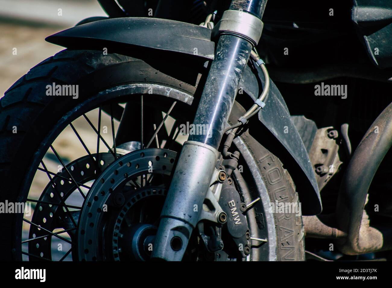 Closeup of a motorcycle rolling in the streets of the city center of ...