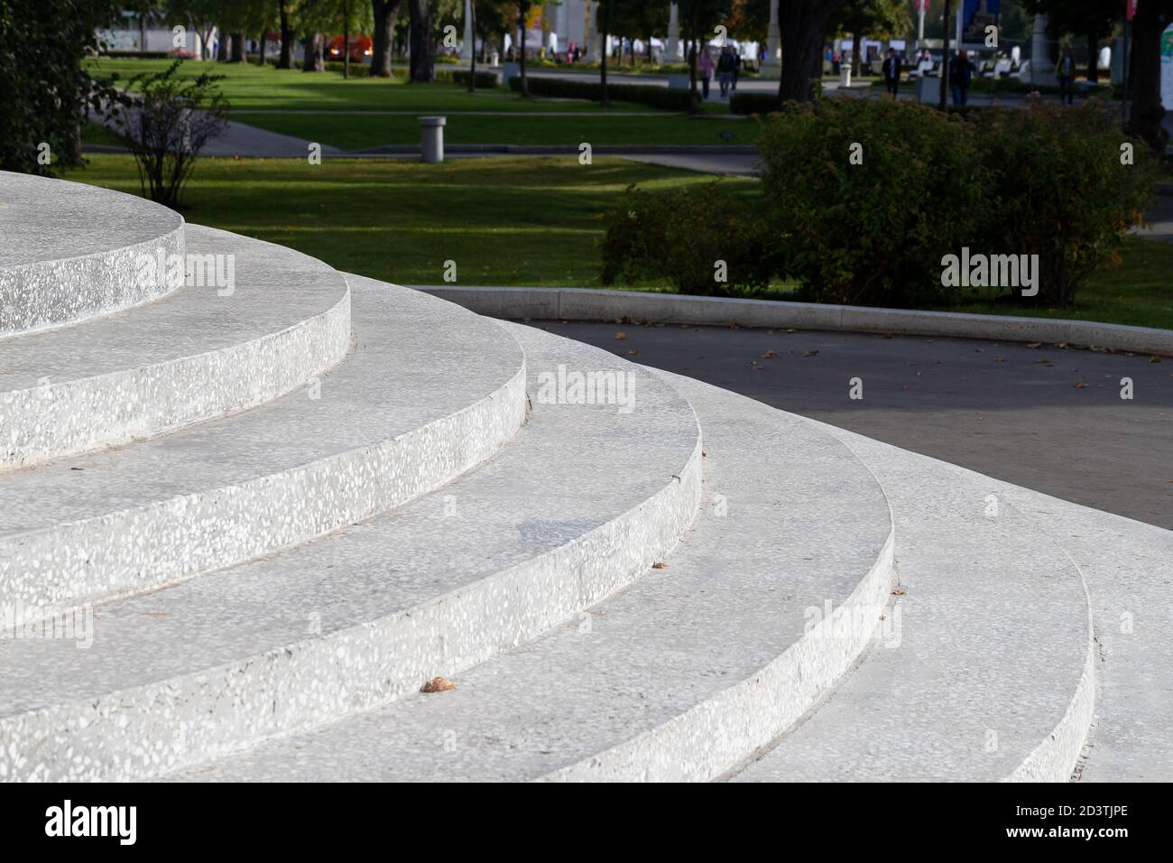 empty concrete steps against city park with people walking Stock Photo ...