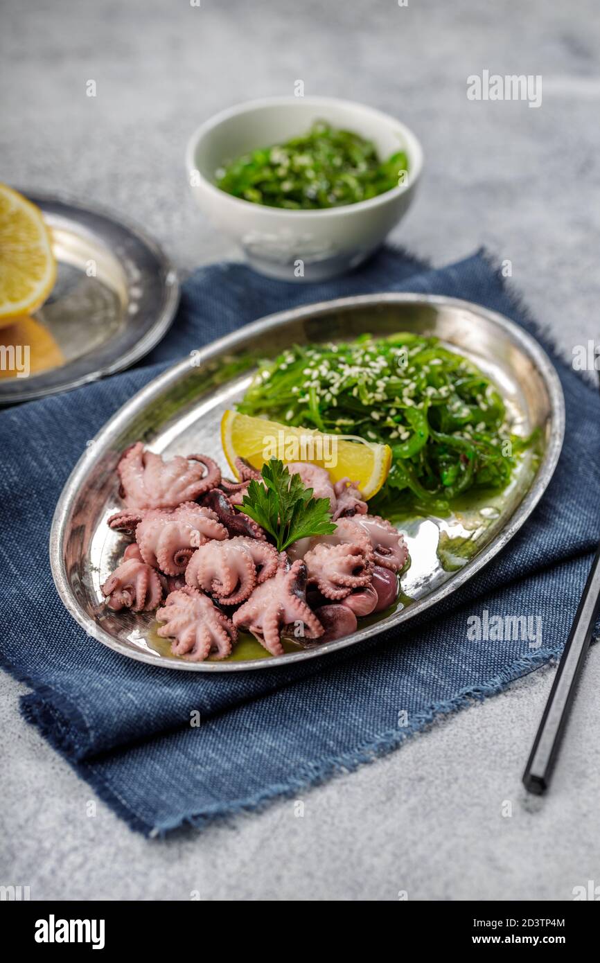 Traditional asian food. Delicious boiled octopus with fresh wakame ...