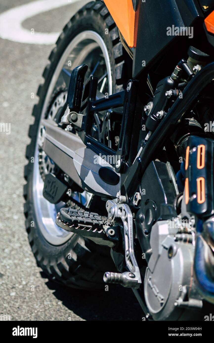 Closeup of a motorcycle rolling in the streets of the city center of ...