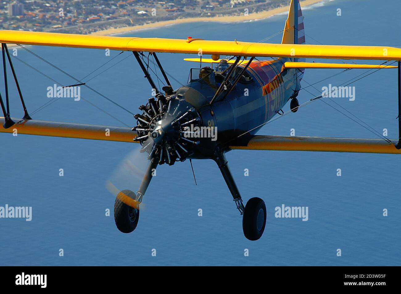 A 1940's Boeing N2S Stearman trainer biplane photographed air-to-air ...