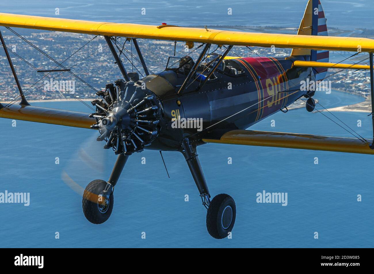 A 1940's Boeing N2S Stearman trainer biplane photographed air-to-air ...