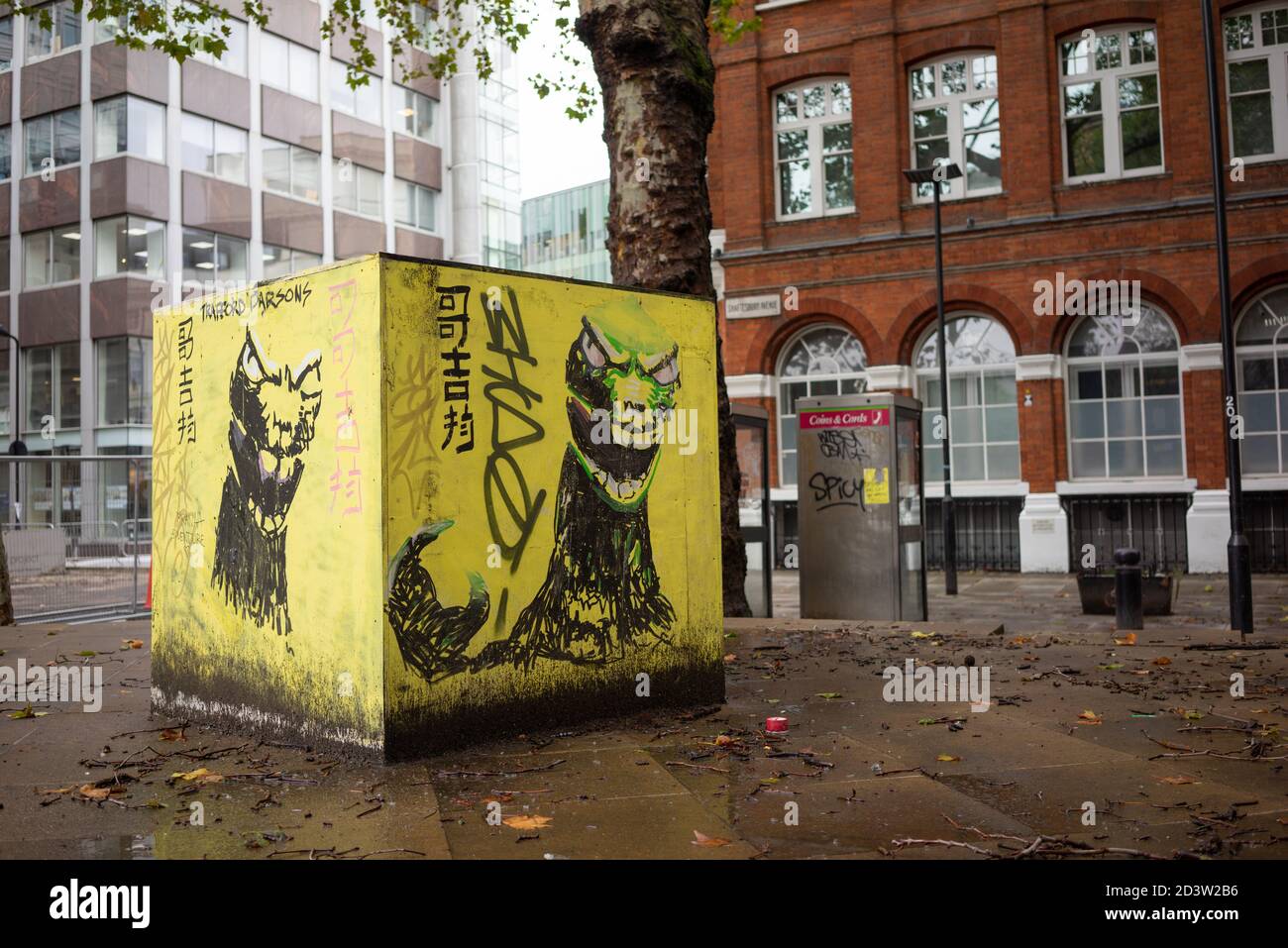 A yellow cube in a London street with graffiti during autumn Stock ...