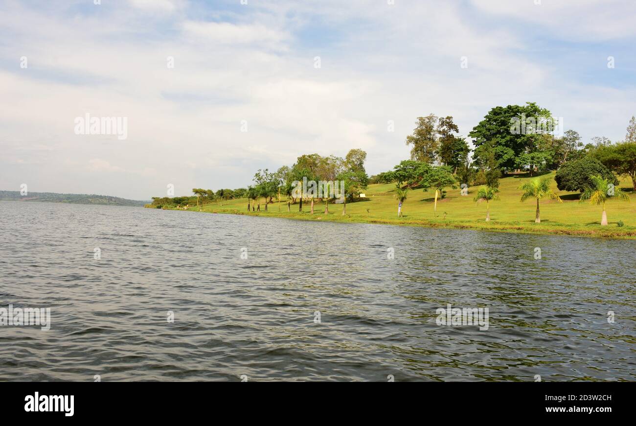 Lake Muhazi water and small hills on the shores and the blue sky with ...