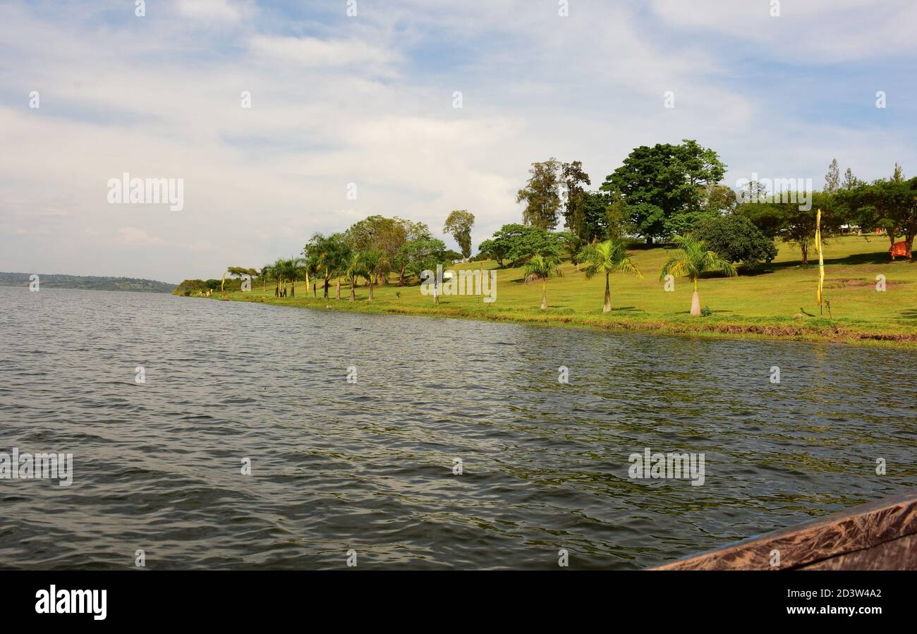 Lake Muhazi water and small hills on the shores and the blue sky with ...