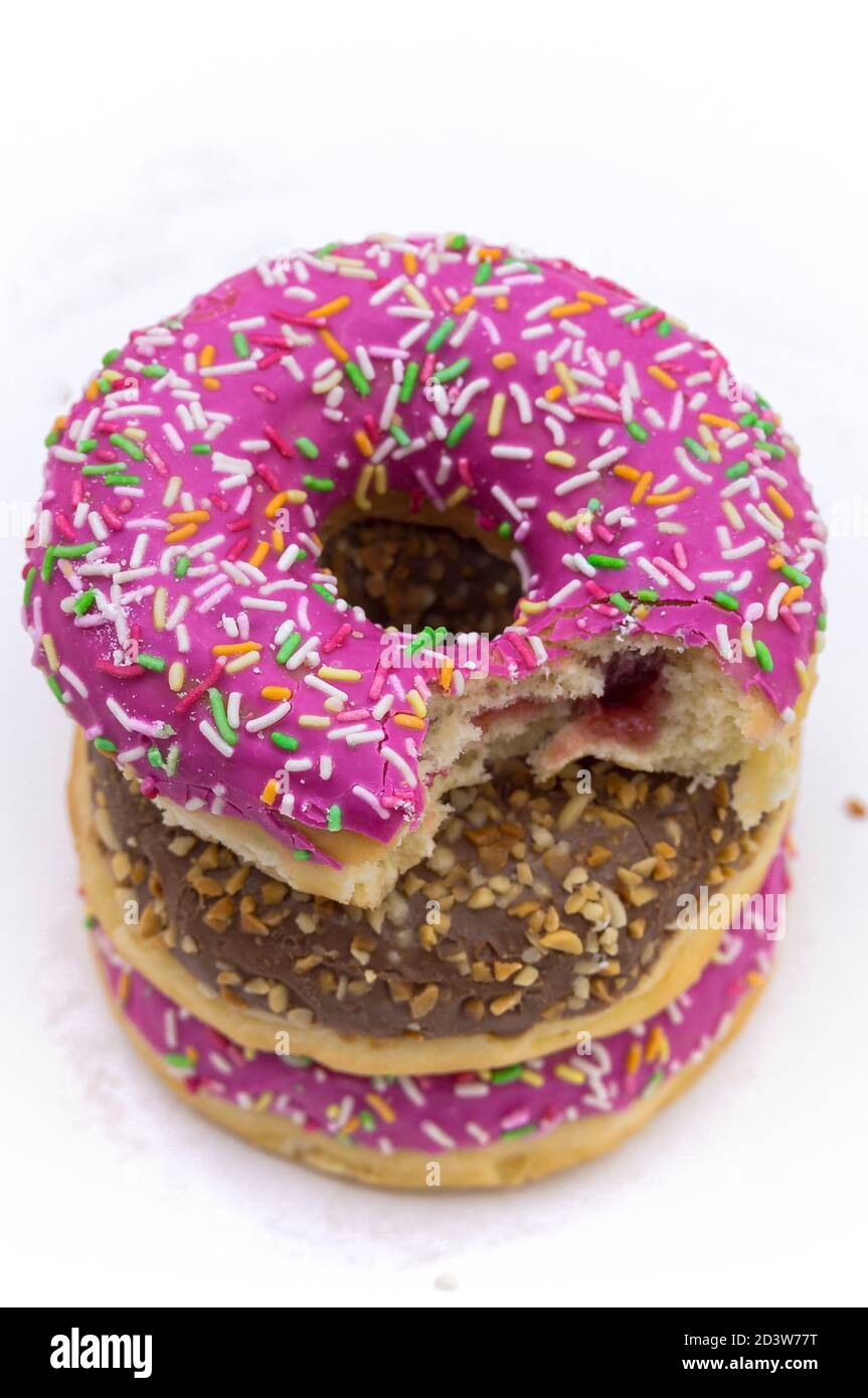 chocolate and berry doughnut, walnut donut on a white background, pink ...