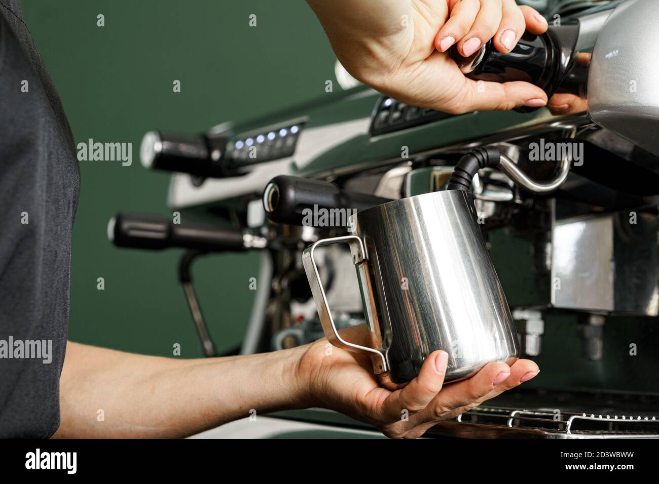 Woman coffee shop worker preparing coffee on professional coffee ...