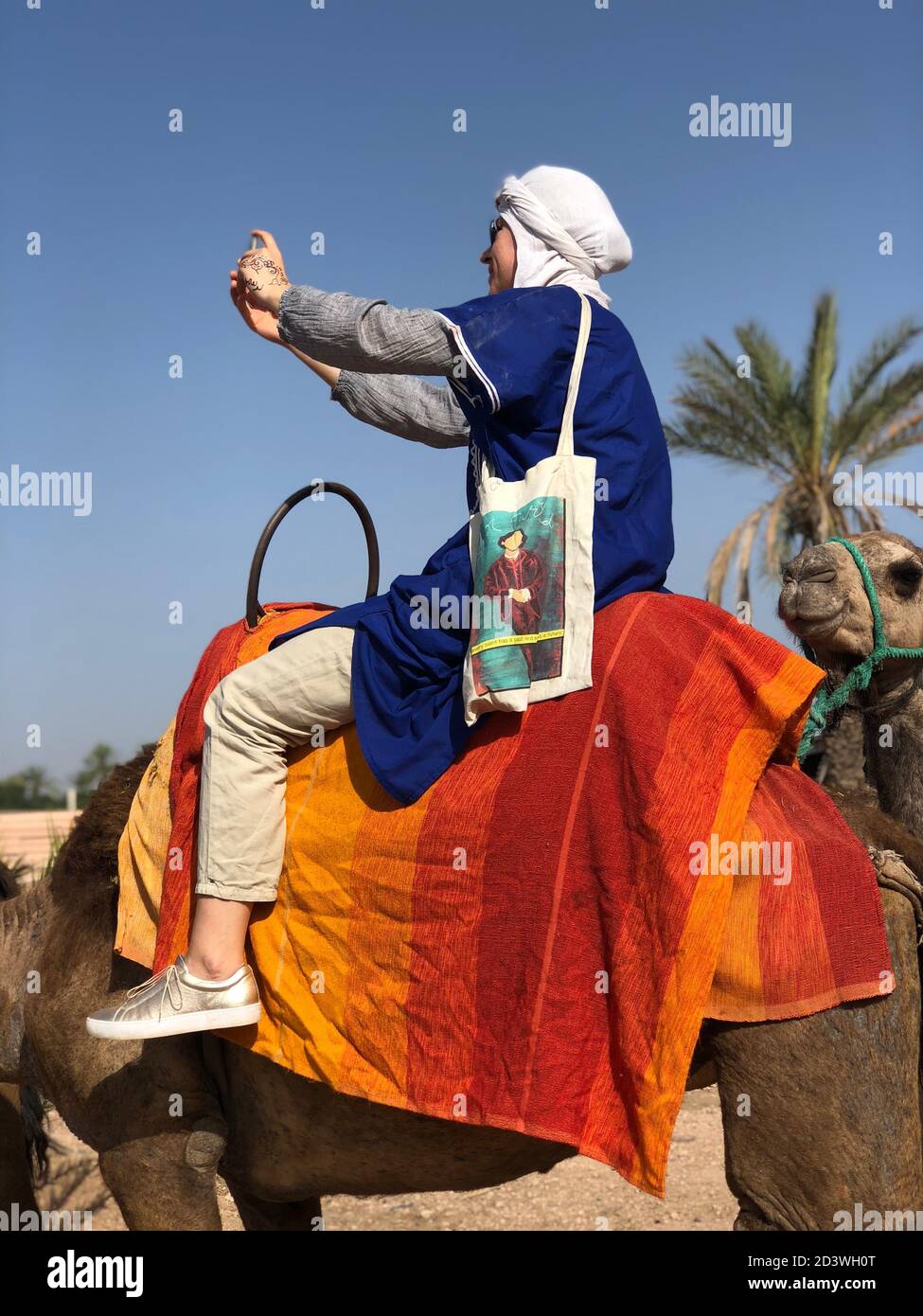 Tourist woman rides a camel during the tourist camel tour Stock Photo ...