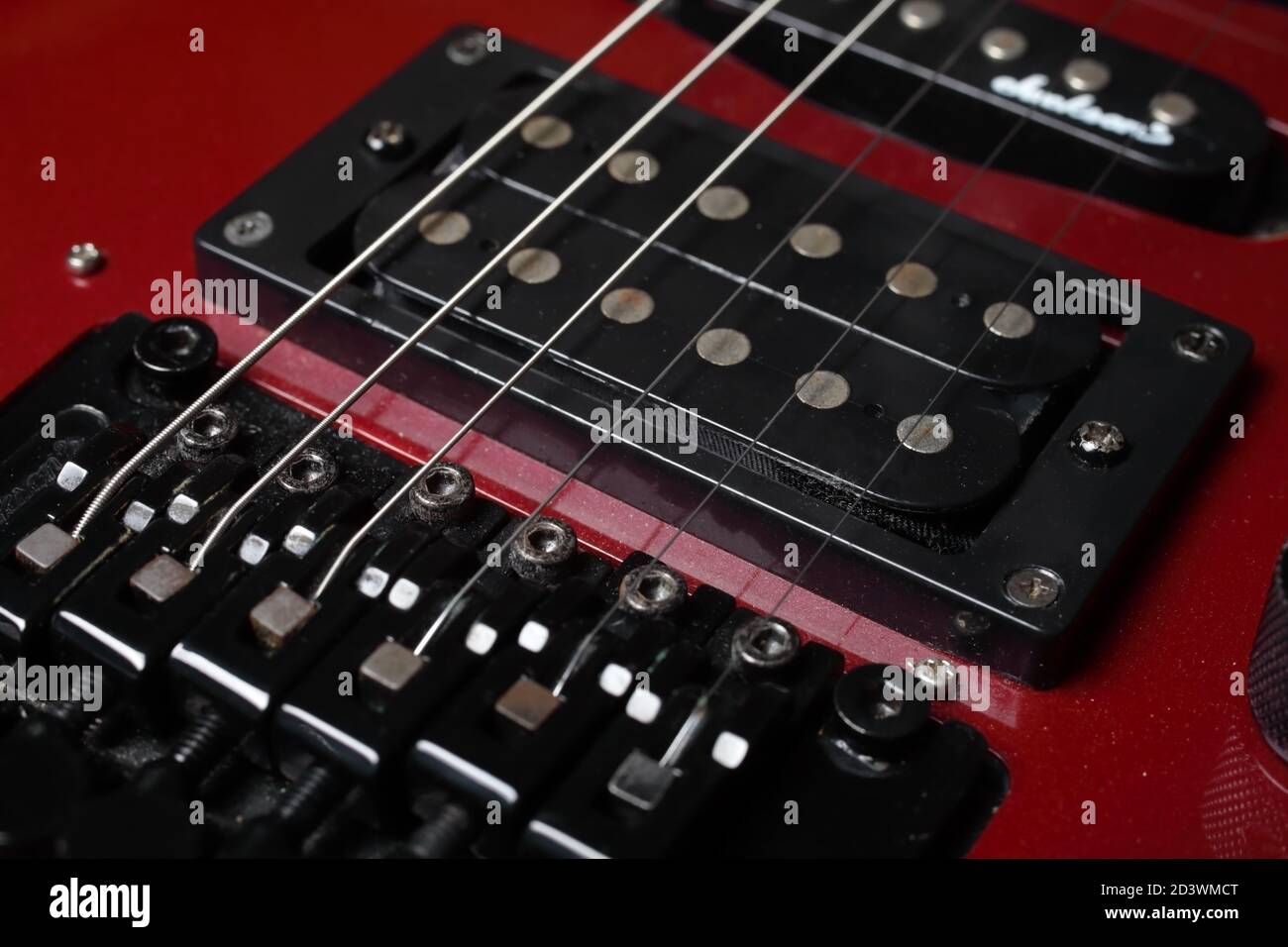 Red electric guitar. Electric guitar pickups close-up. Selective focus ...