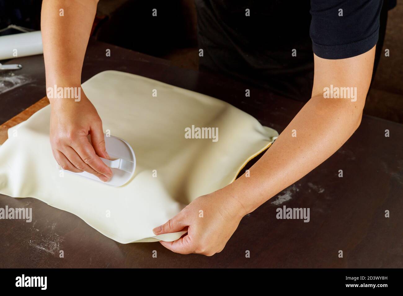 Woman making cake with fondant for party. Technique of baker Stock ...