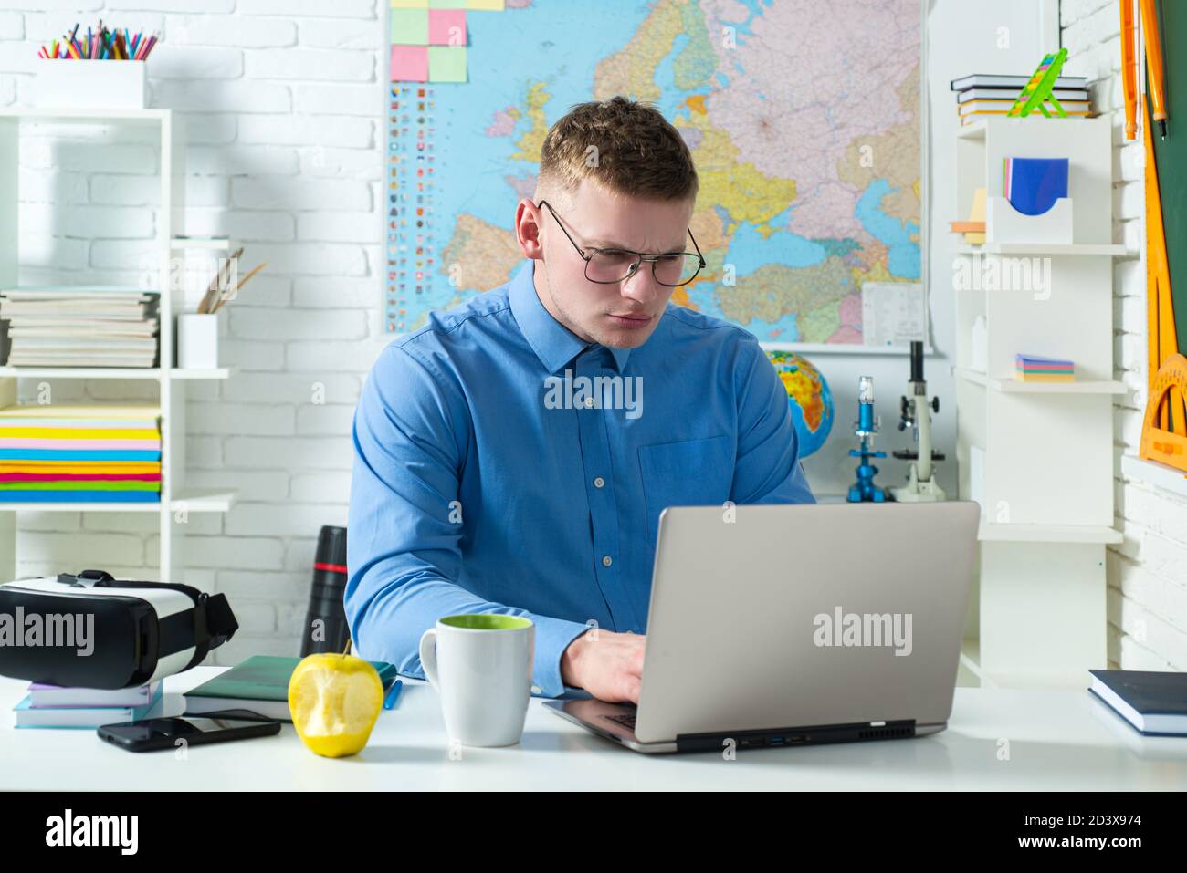 Handsome college boy using notebook. Caucasian male student in ...