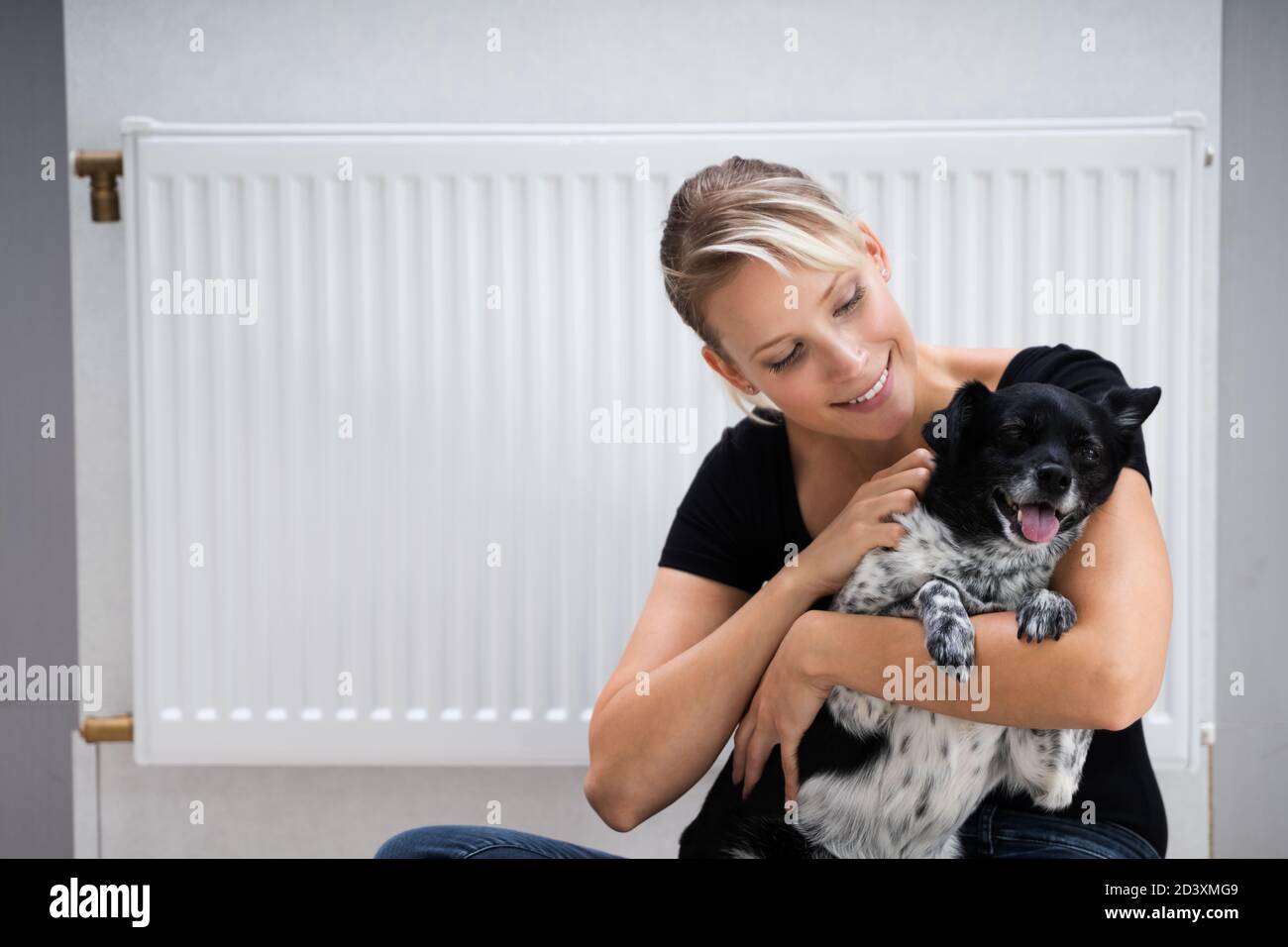 Happy Warm Woman With Dog Near Thermostat Heating Radiator Stock Photo ...