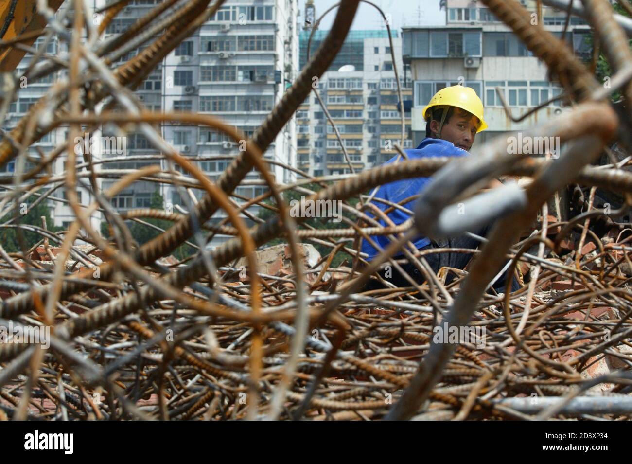 A CHINESE MIGRANT WORKER TAKES A BREAK FROM COLLECTING RECYCLABLE ...