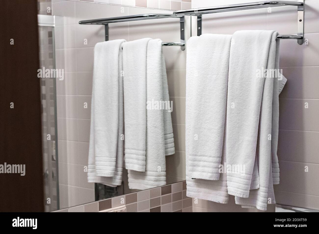 two white towels on the hanger Stock Photo - Alamy