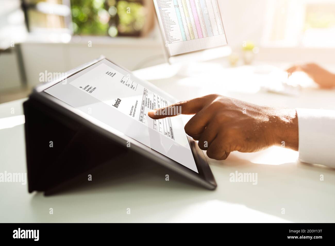 African Advisor Tax Audit Using Invoice Software Stock Photo - Alamy