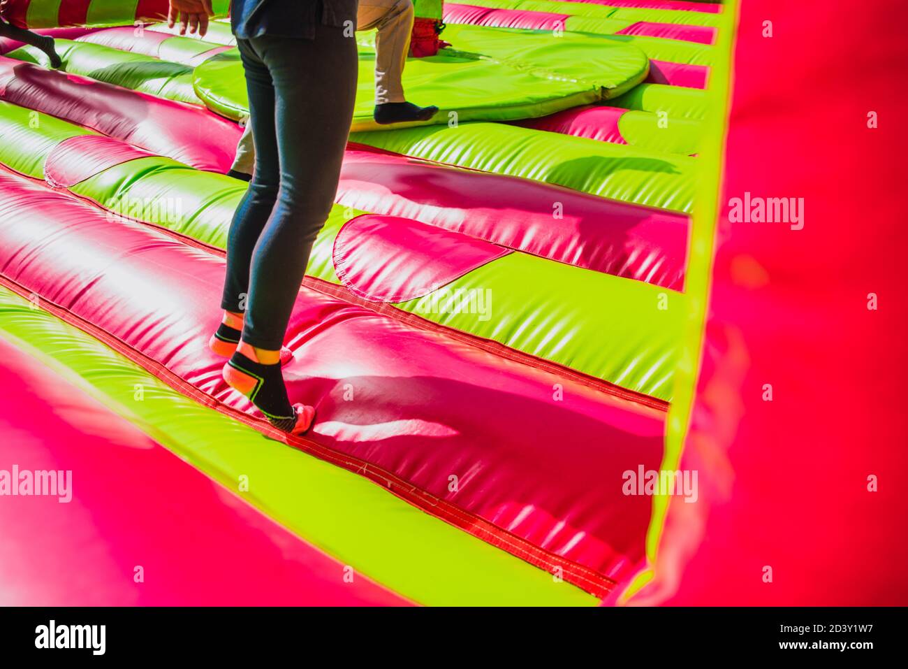 Legs of girl jumping with energy is a bouncing castle Stock Photo - Alamy