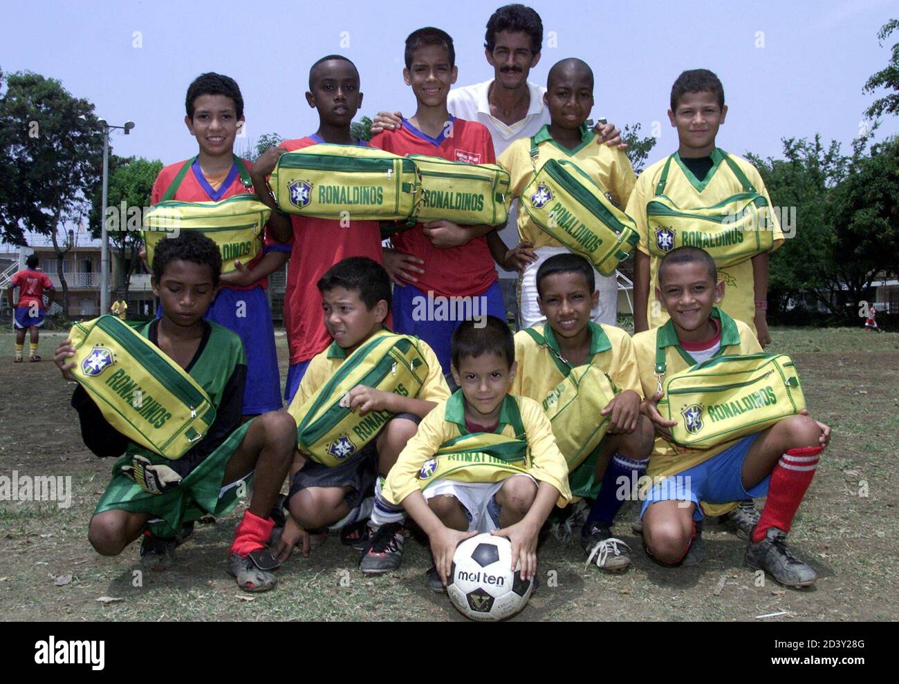 Brazilian children playing football on hi-res stock photography and ...