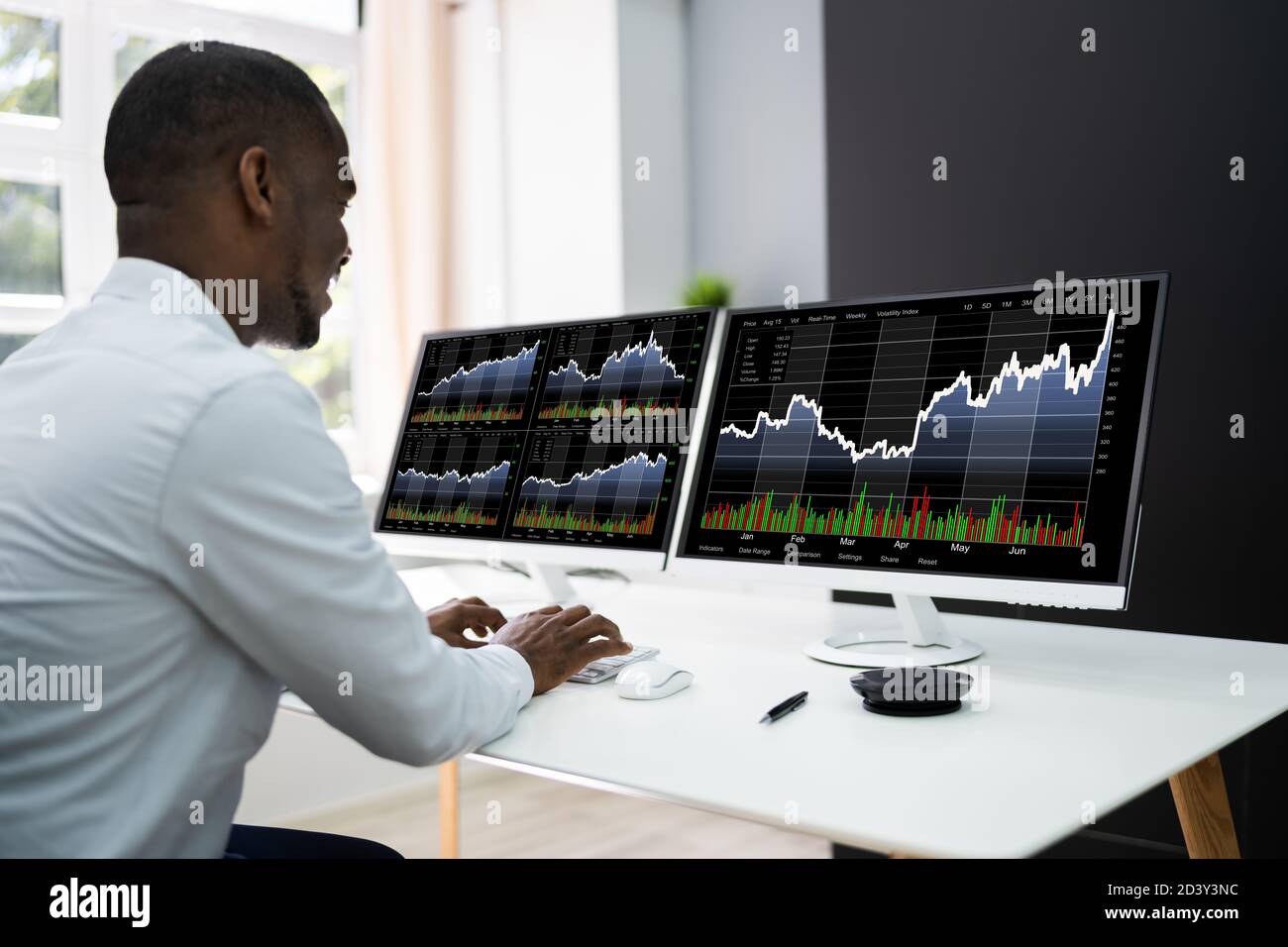 Stock Exchange Analyst Using Multiple Computer Screens Stock Photo - Alamy