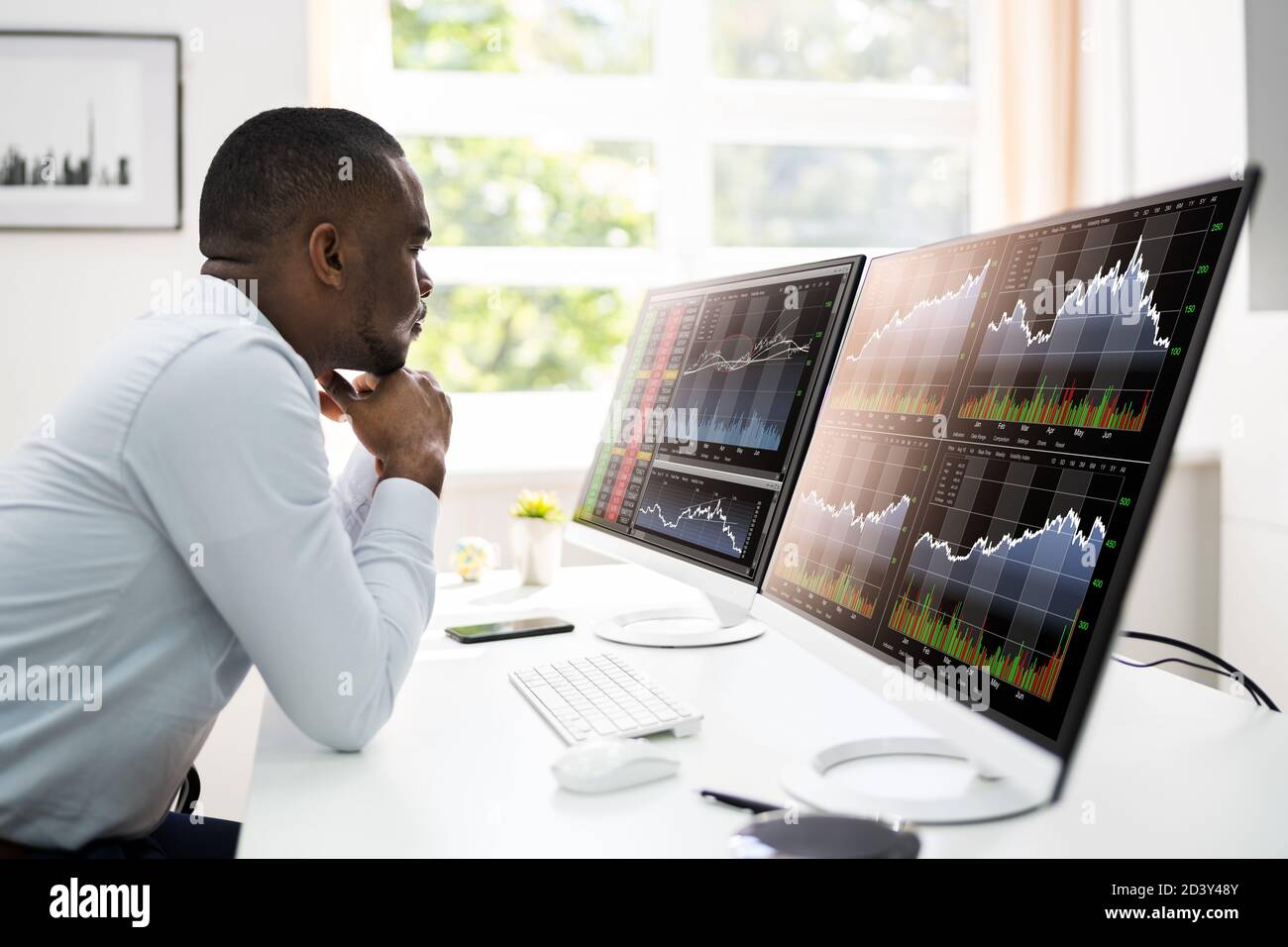 Stock Exchange Analyst Using Multiple Computer Screens Stock Photo - Alamy
