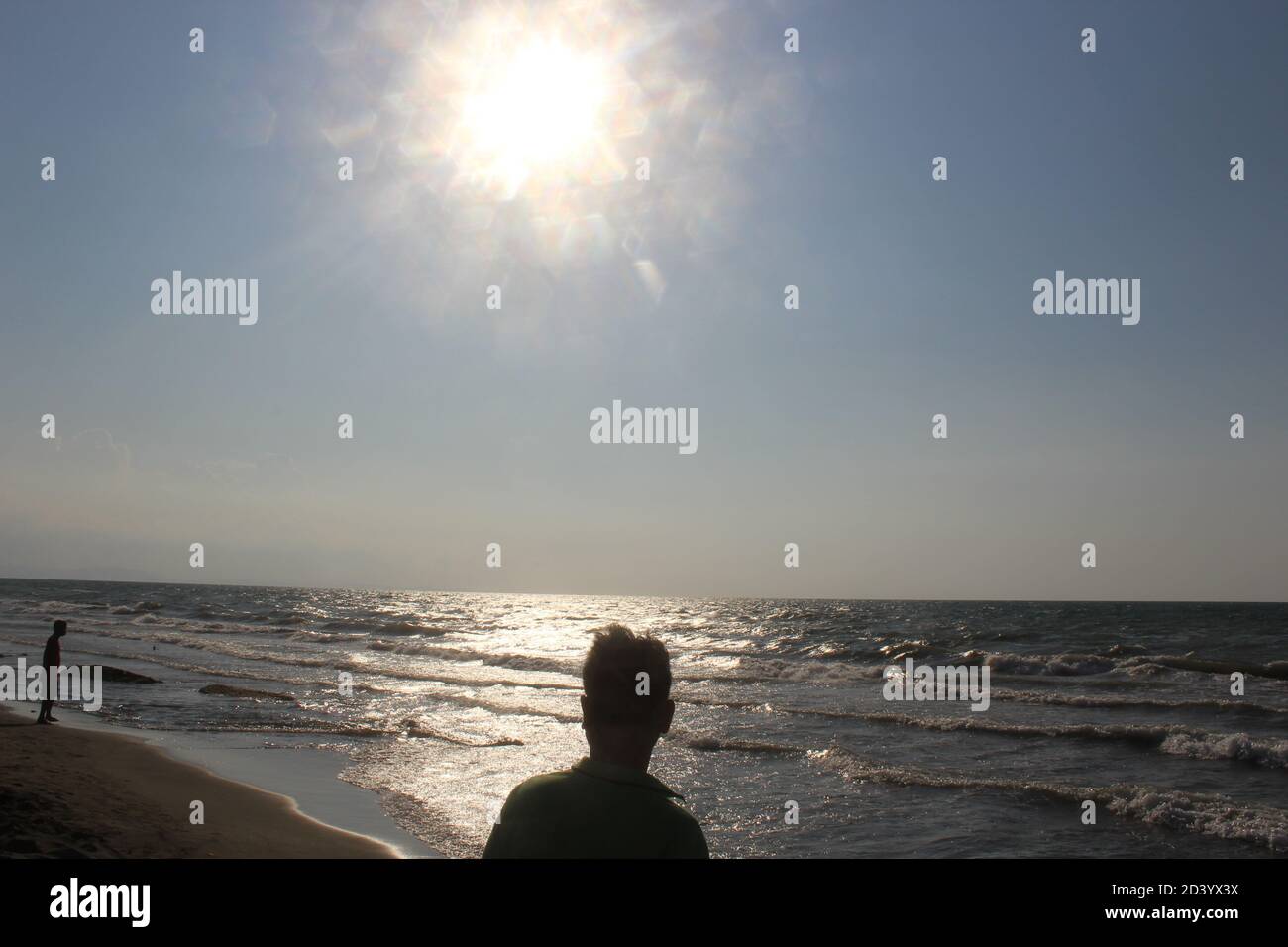 A guy thinking his wife at the sunset beach Stock Photo - Alamy