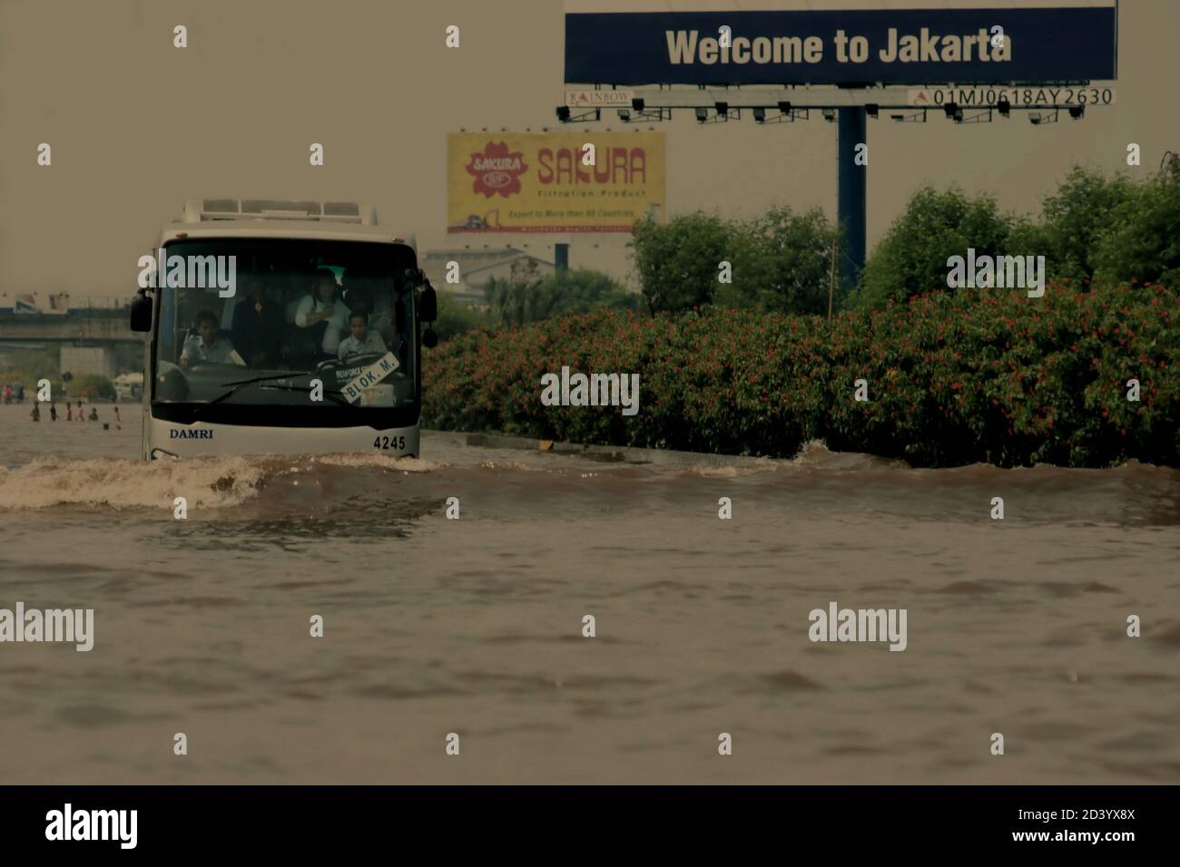 Airport shuttle bus moving through floodwater, after torrential rain ...