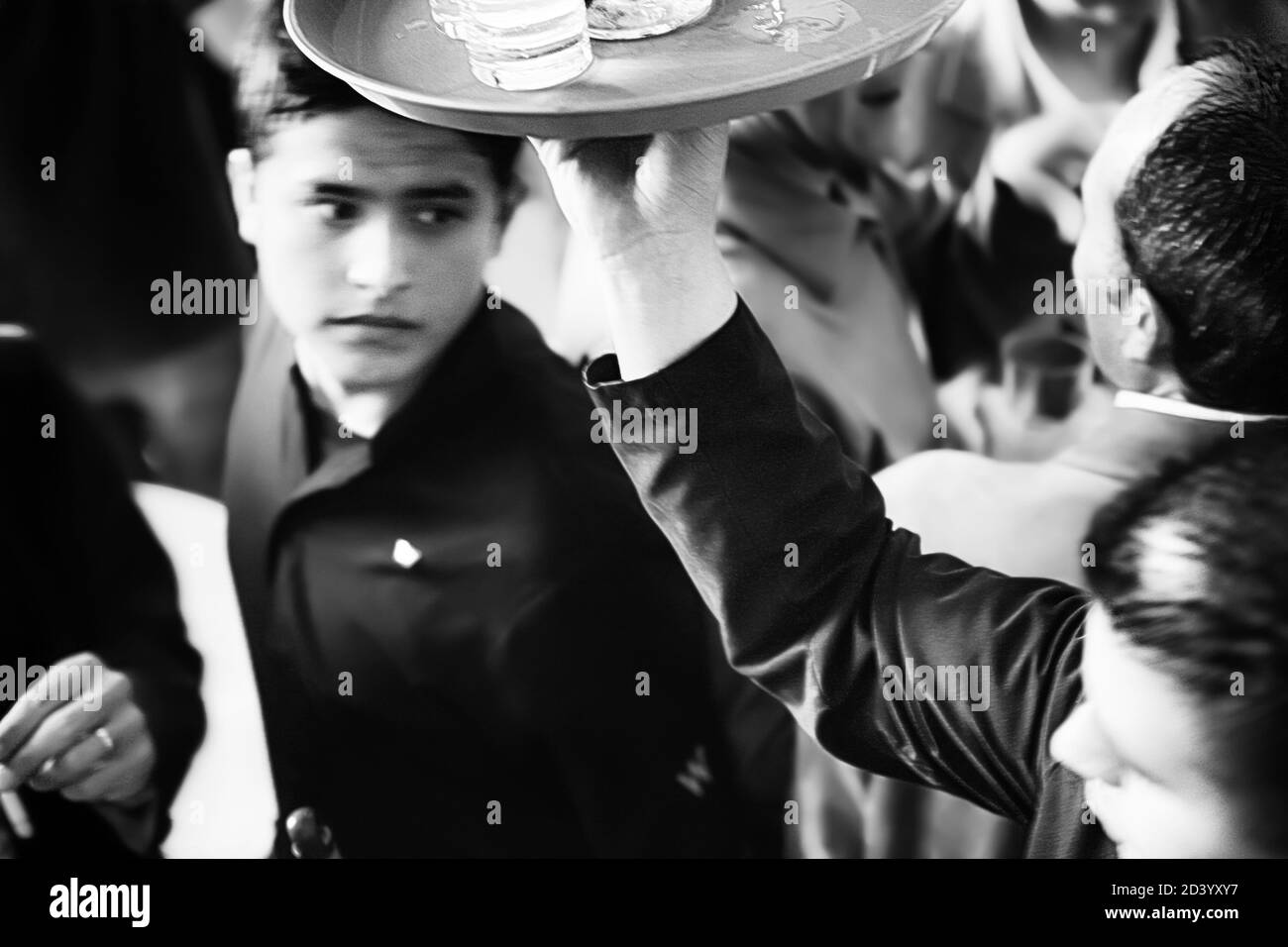 Waiter has a stealthy gaze to a work companion during a middle class ...