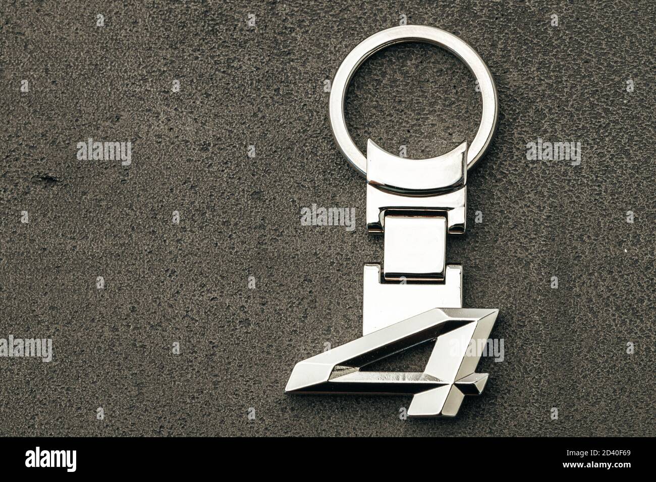 Metal number Four car key on dark concrete background Stock Photo - Alamy