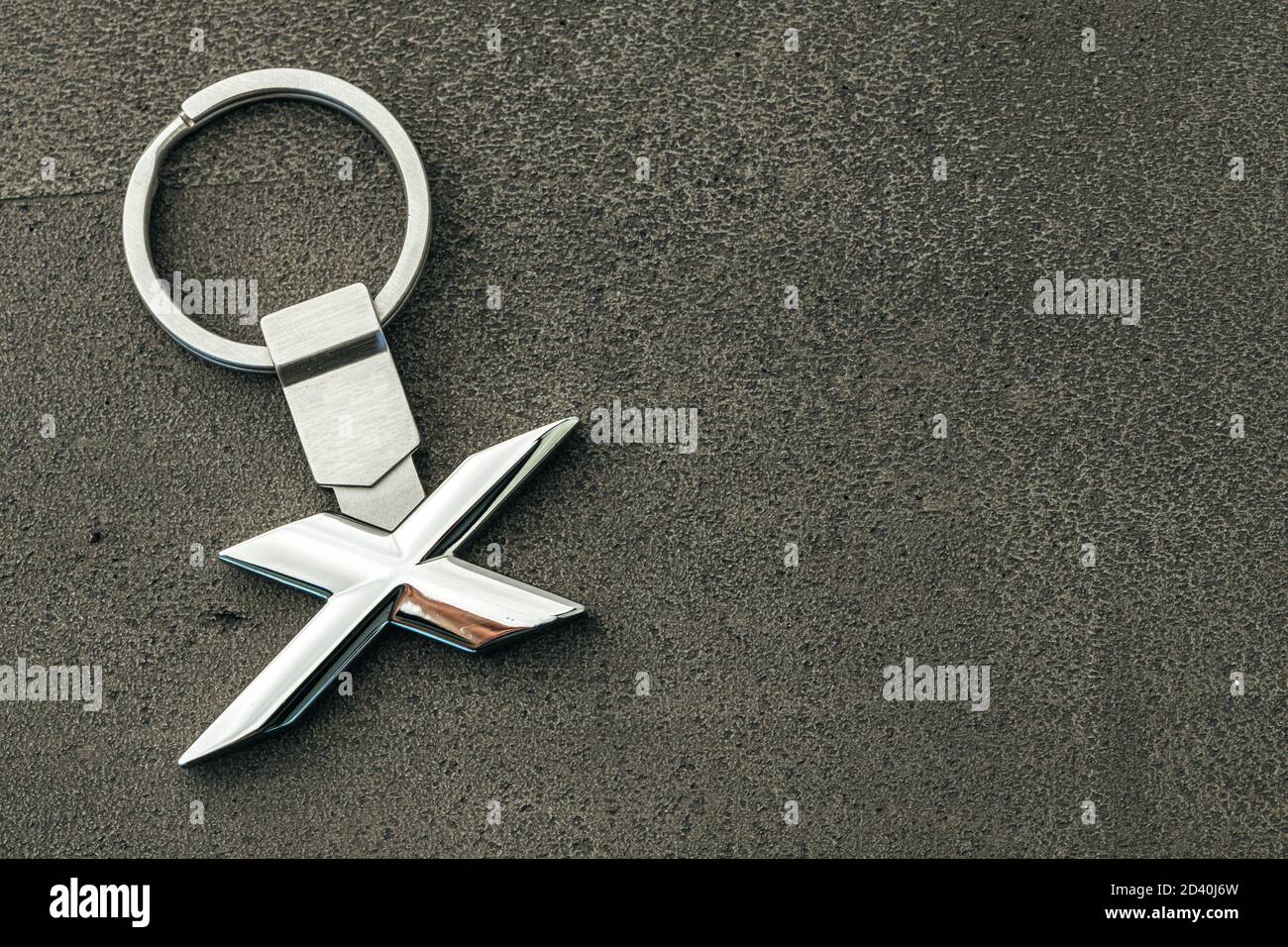 Metal letter X car key on dark concrete background Stock Photo - Alamy