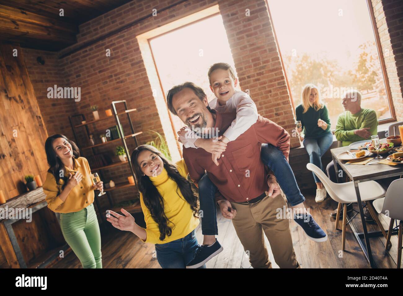 Photo of full family gathering six people two small kids play dad ...