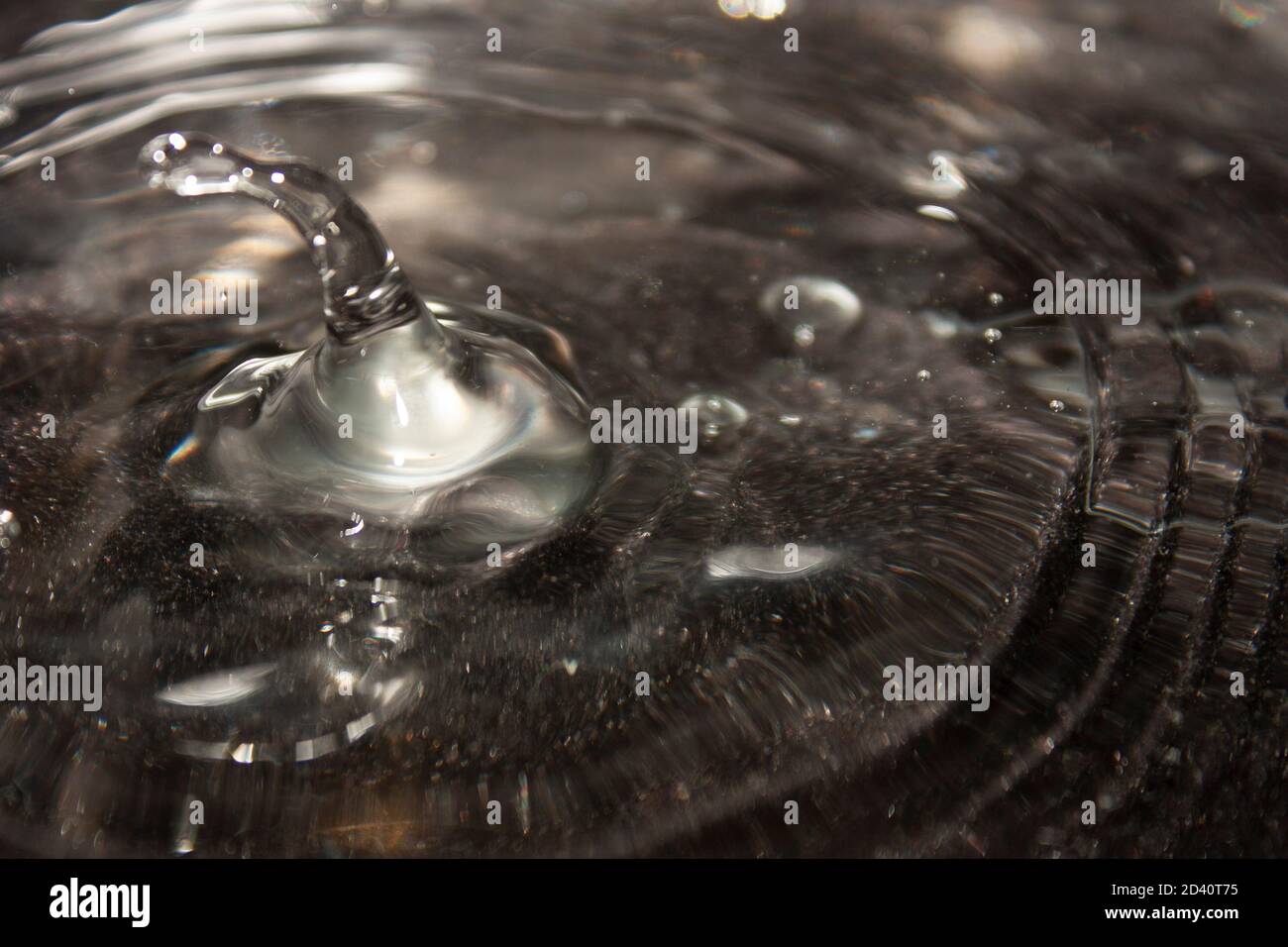 Splash formation from drops of water falling on a liquid surface scenes ...