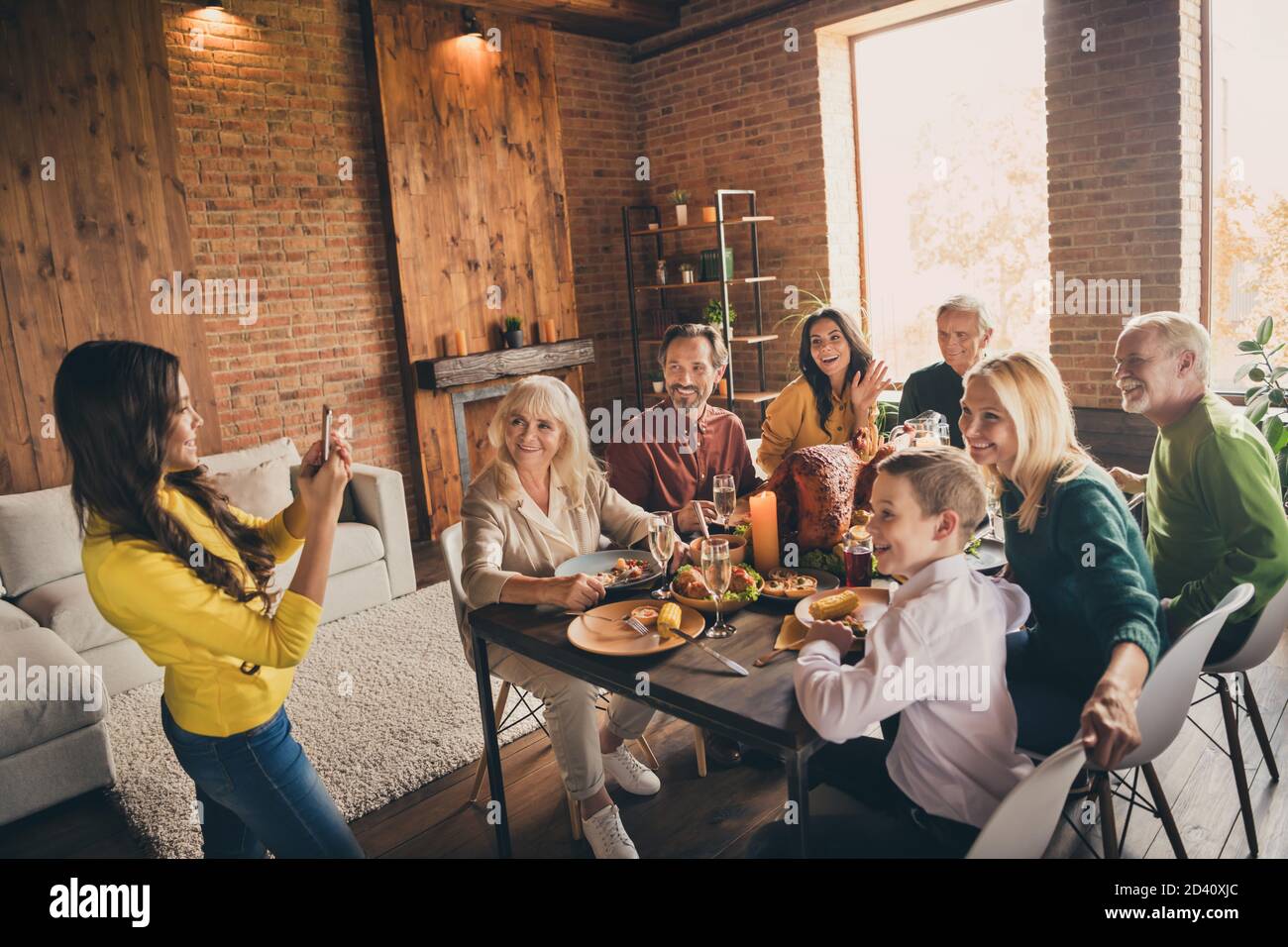 Photo of full family gathering eight people small daughter hold ...