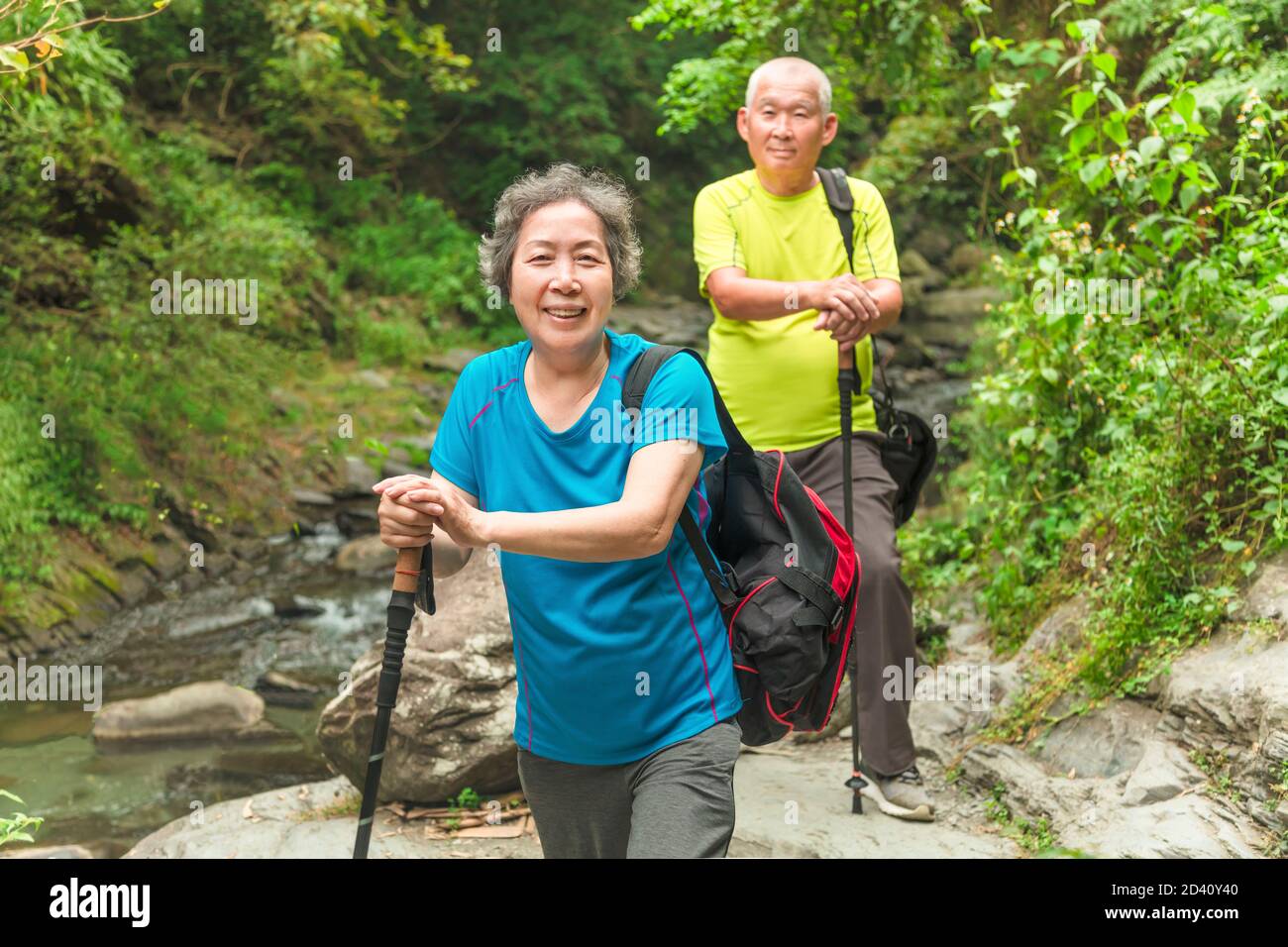 Happy Asian senior couple hiking in nature park Stock Photo - Alamy