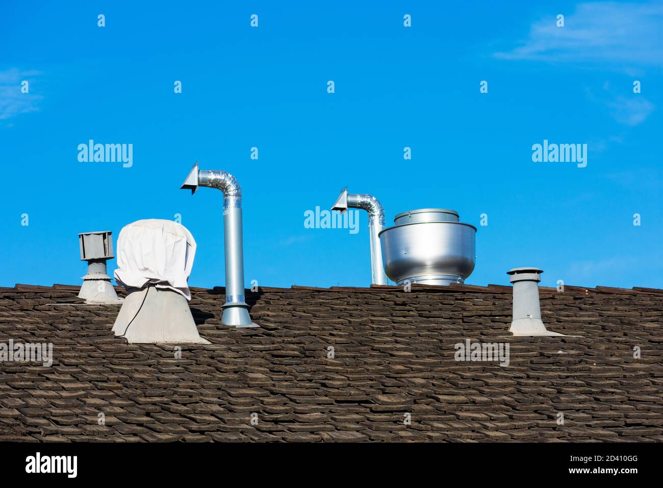 Exhaust system vent and grease trap on wooden roof of a restaurant ...
