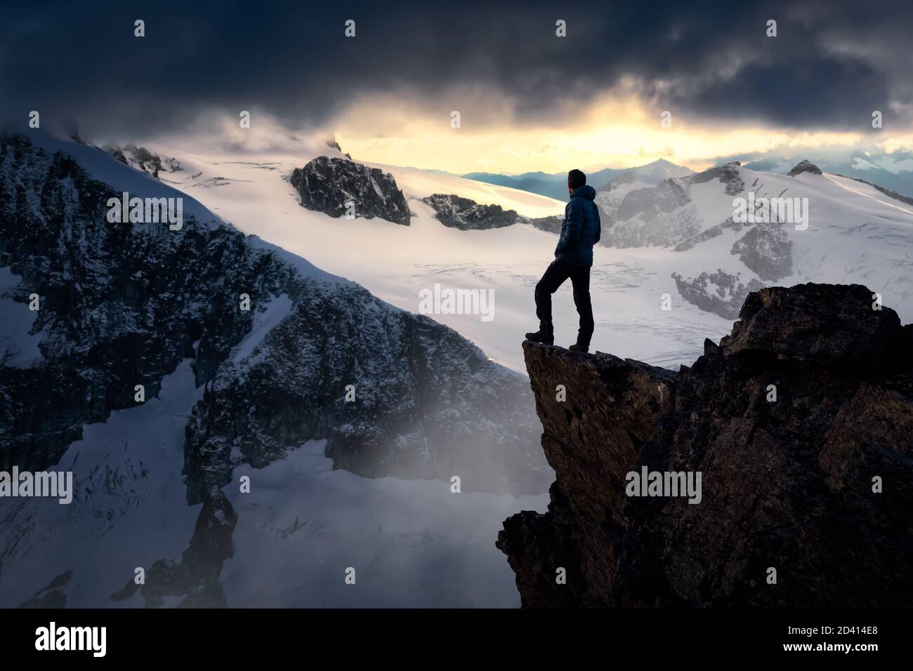 Adventure Man on top of a Mountain Stock Photo - Alamy