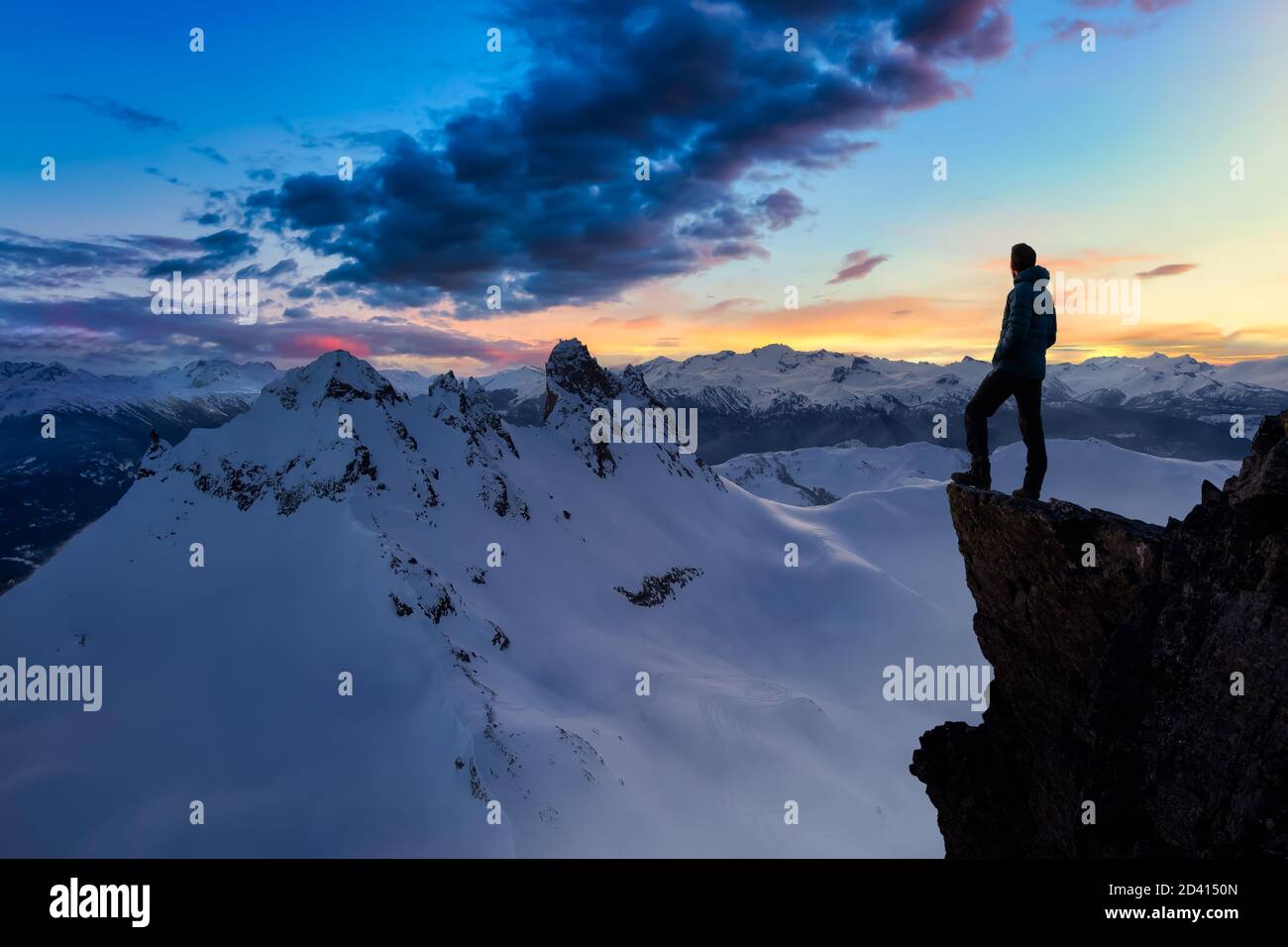 Adventure Man on top of a Mountain Stock Photo - Alamy
