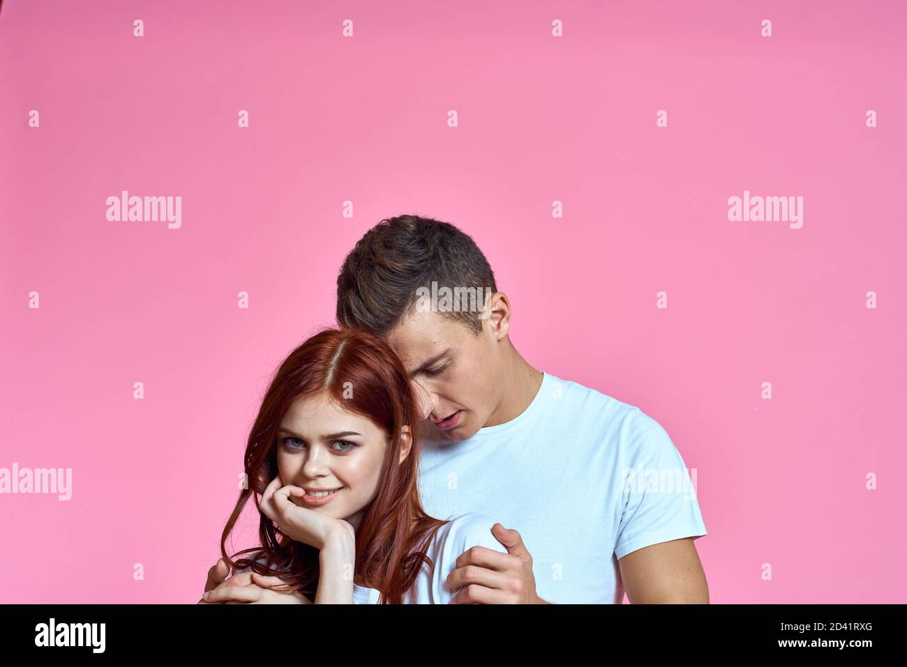 enamored man and woman hugging each other on a pink background cropped ...