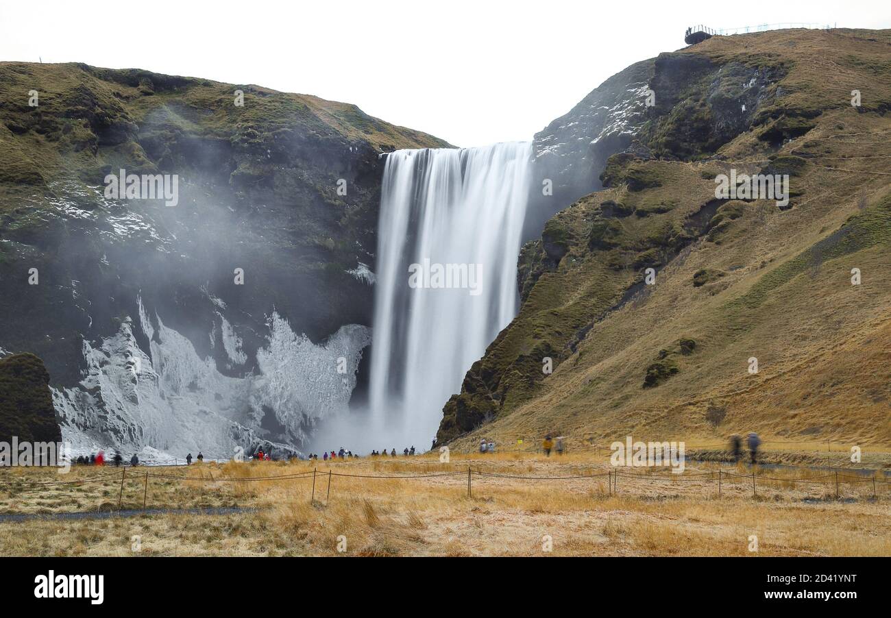 SKOGA, ICELAND - Dec 10, 2018: Many tourists visit Skogafoss, one of ...