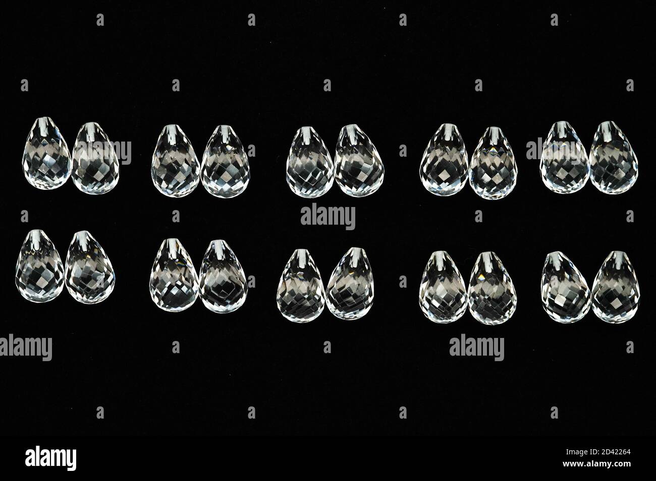 Pairs of pear-shaped crystals on a black surface Stock Photo - Alamy