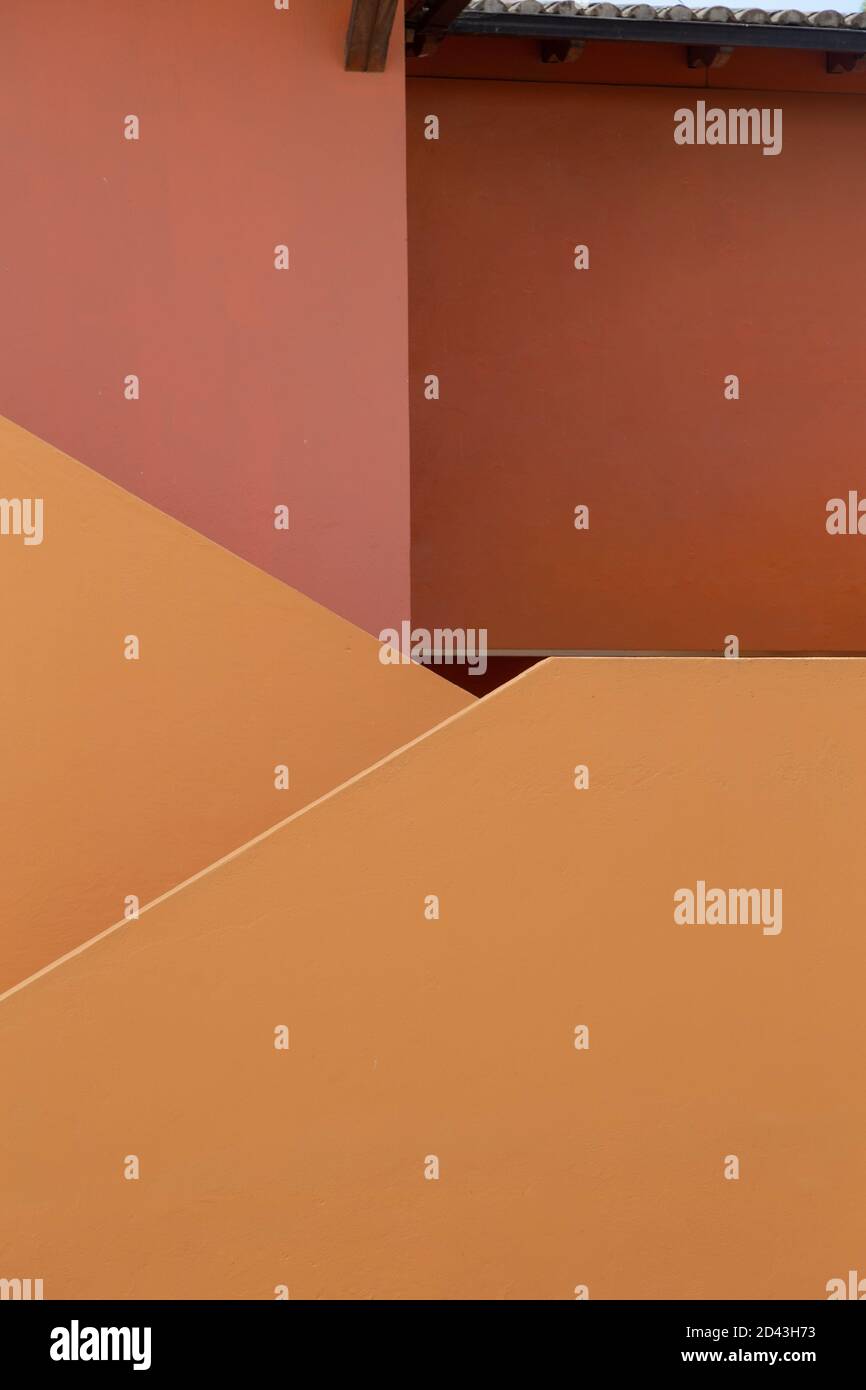 close-up to plain pink and orange wall, with straight lines, modern ...