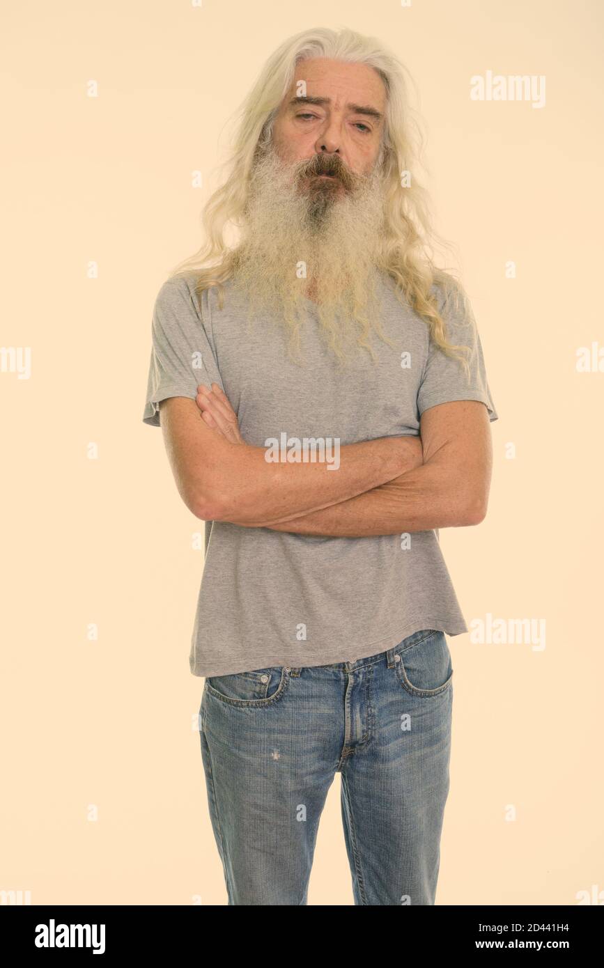 Studio shot of senior bearded man standing with arms crossed Stock ...