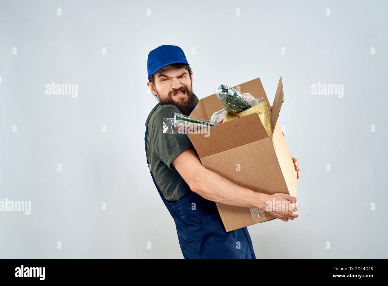 Male worker loading delivery boxes in hands packing lifestyle Stock ...