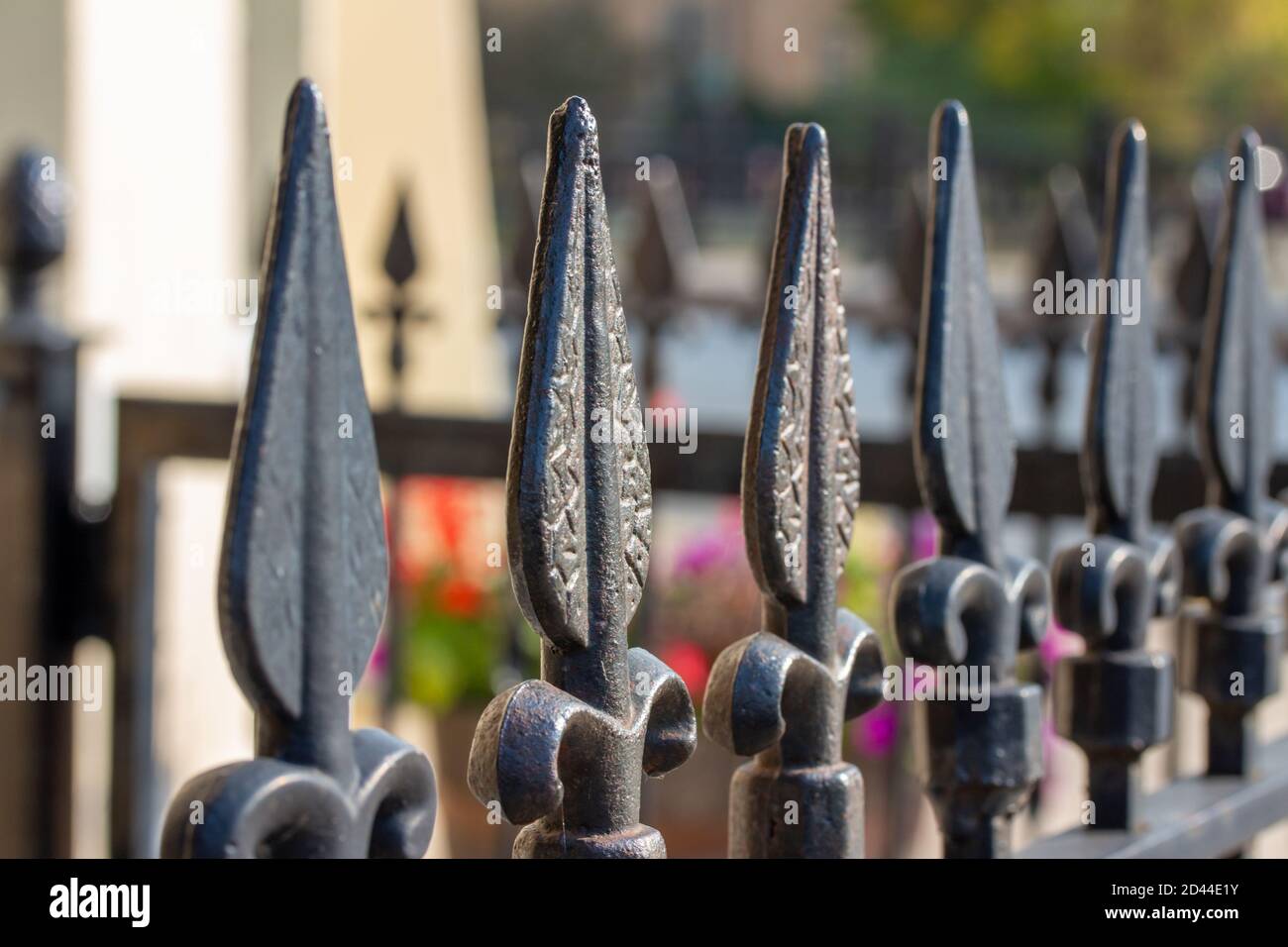 Close up view of a traditional black iron fence posts along an urban ...
