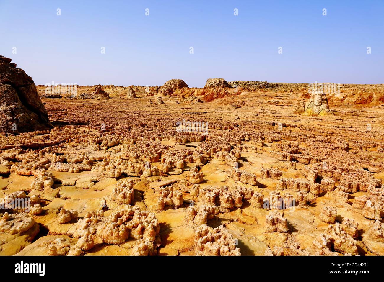 Rocky outcroppings rise above the Dallol salt flats, once covered in a ...