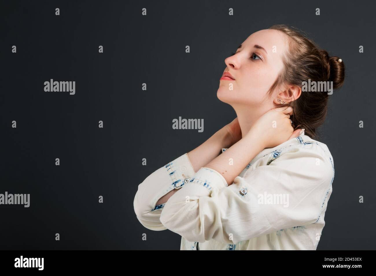 Tired young girl wrapped her arms around her neck Stock Photo - Alamy