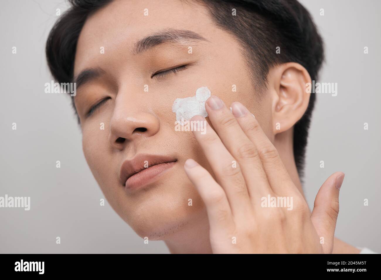 grooming, skin care and people concept - smiling young indian man ...