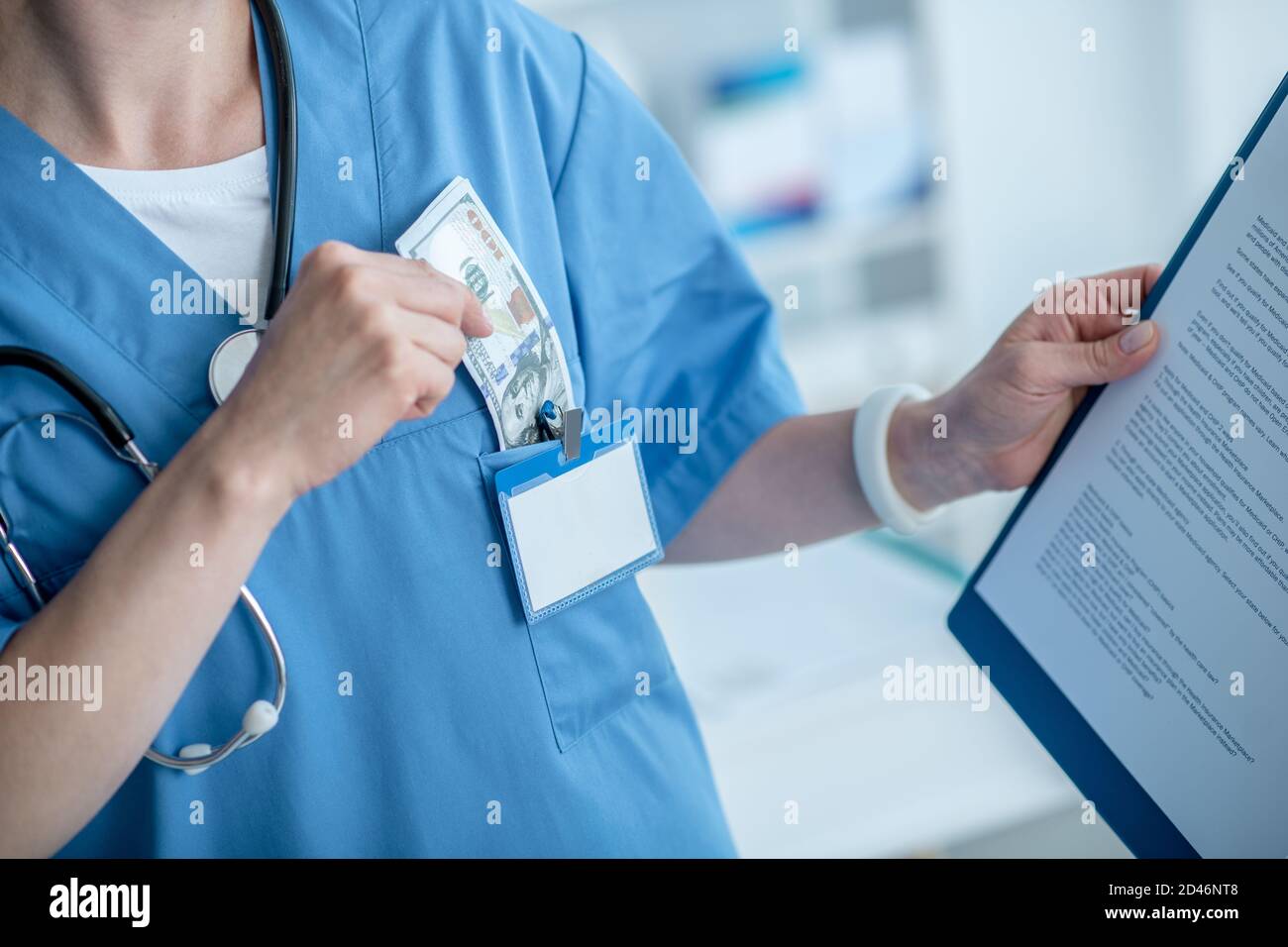 Woman in a lab coat putting money to the pocket Stock Photo - Alamy