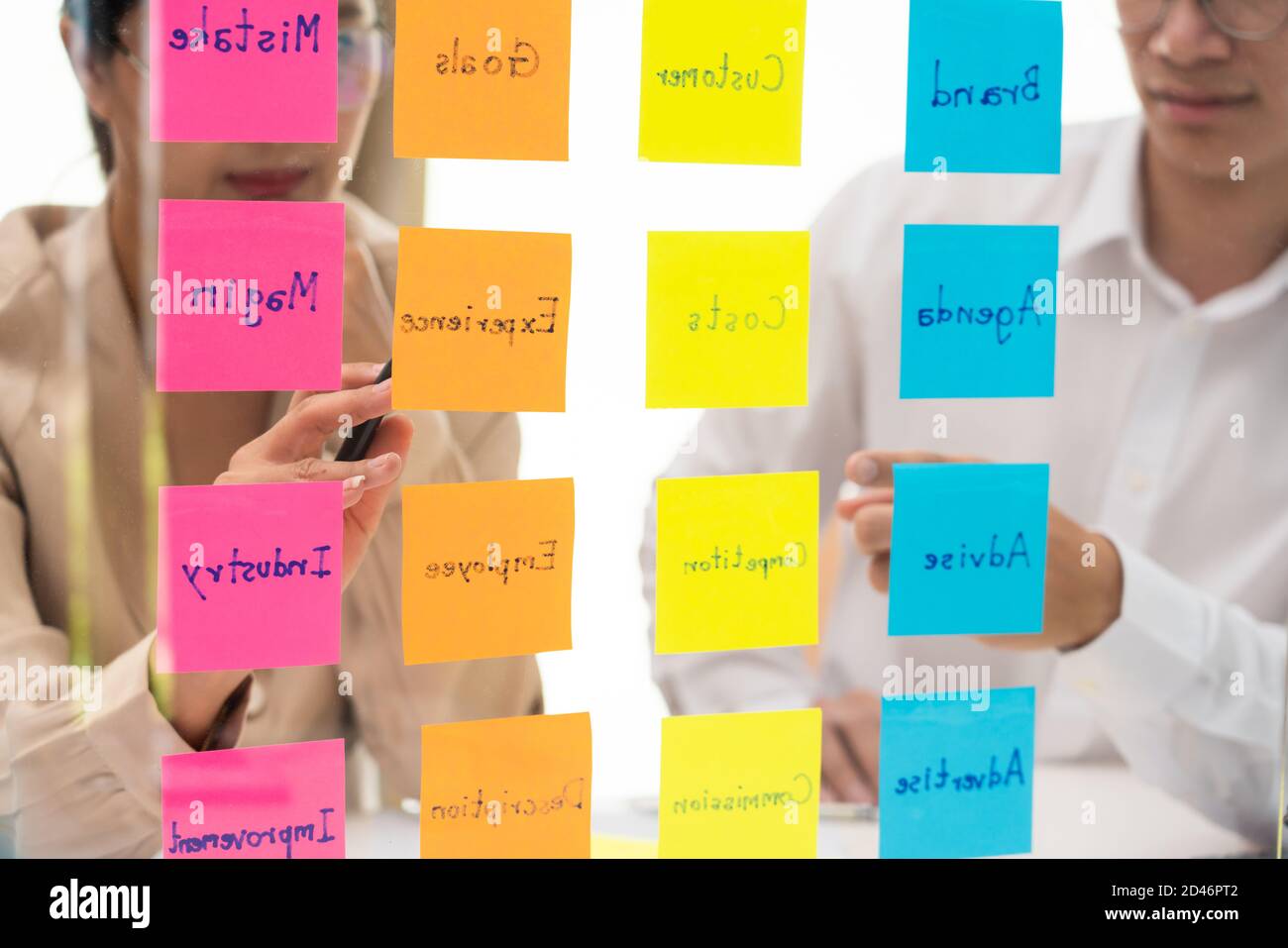 business people planning startup project placing sticky notes session ...