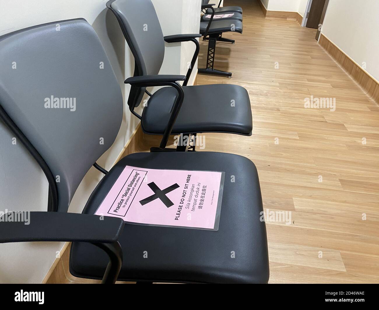 Chairs with "no sitting" social distancing laminated signs due to the ...