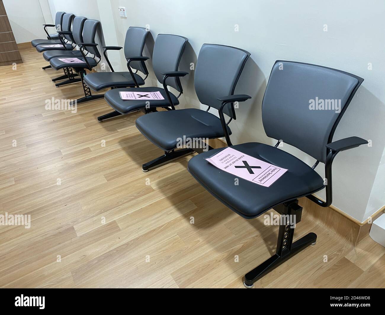 Chairs with "no sitting" social distancing laminated signs due to the ...