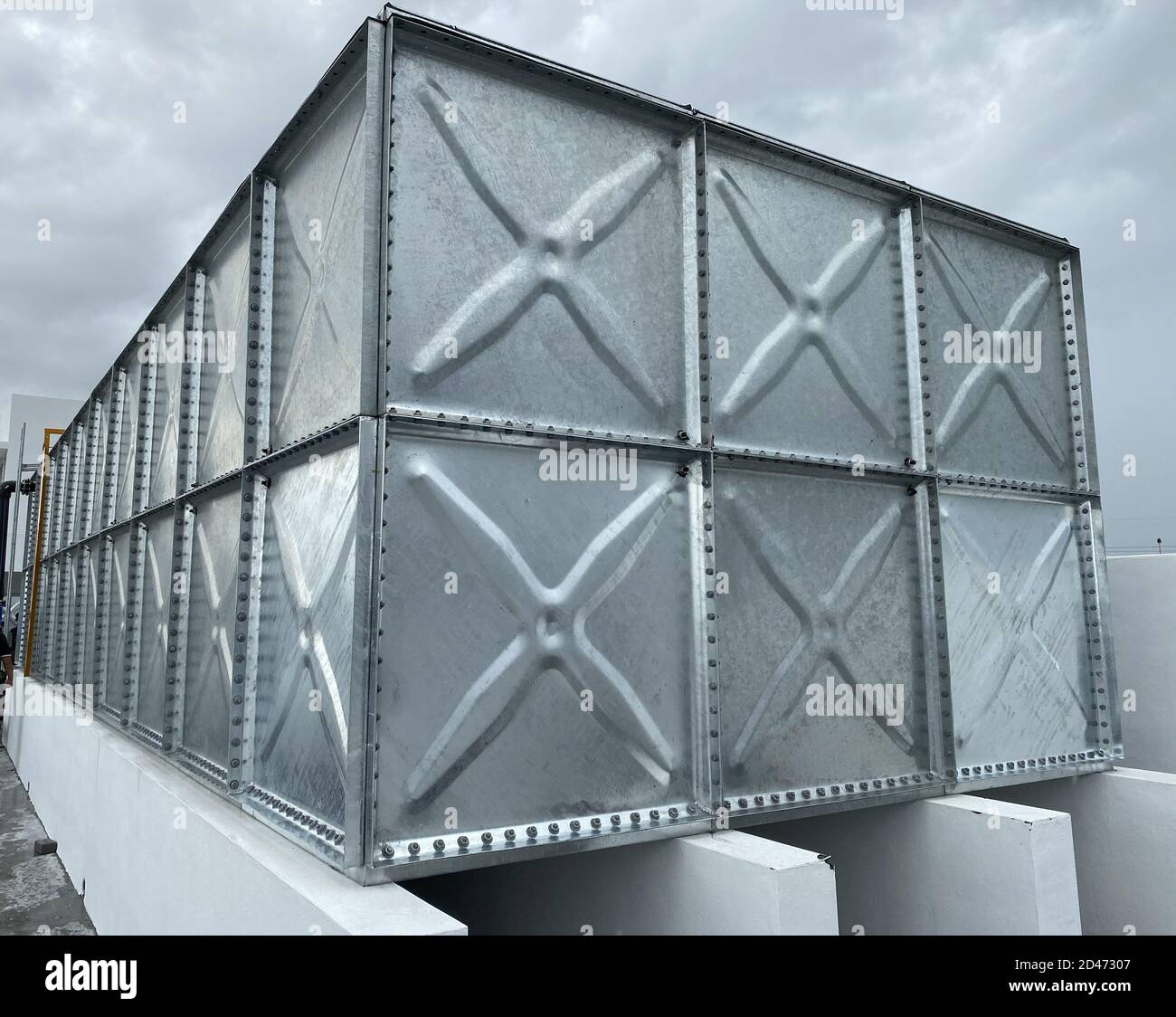 View of water tanks holding drinking water standing on concrete plinths ...